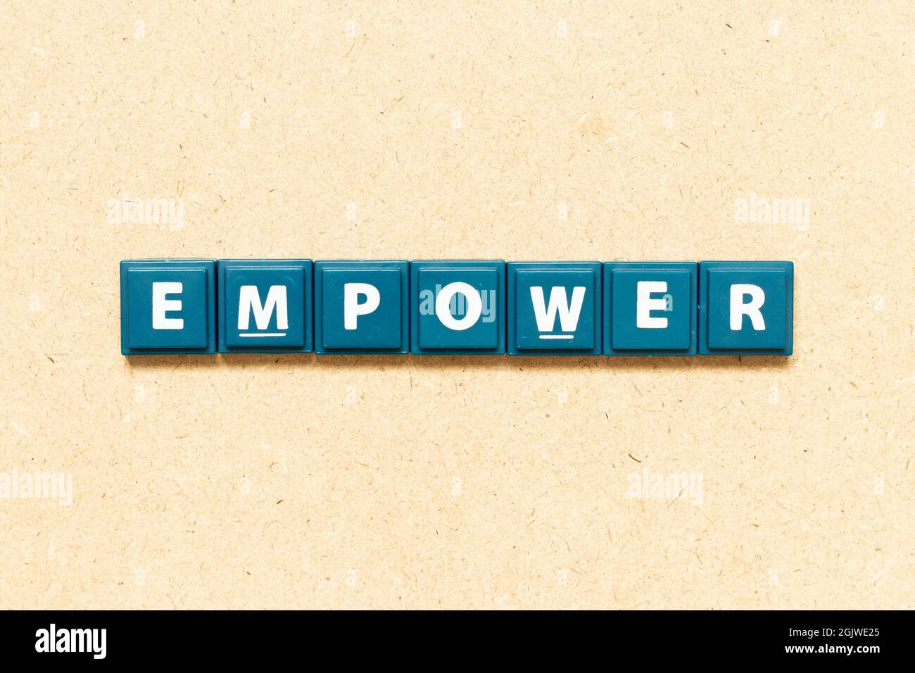 Tile alphabet letter in word empower on wood background Stock Photo - Alamy