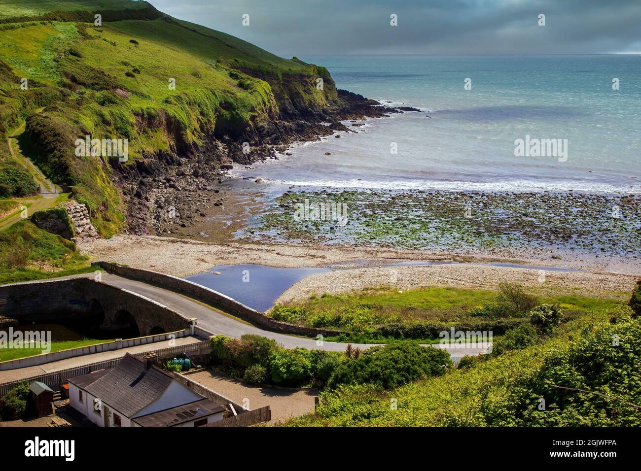 Bridge crossing small rivulet on the route along the shore Stock Photo ...