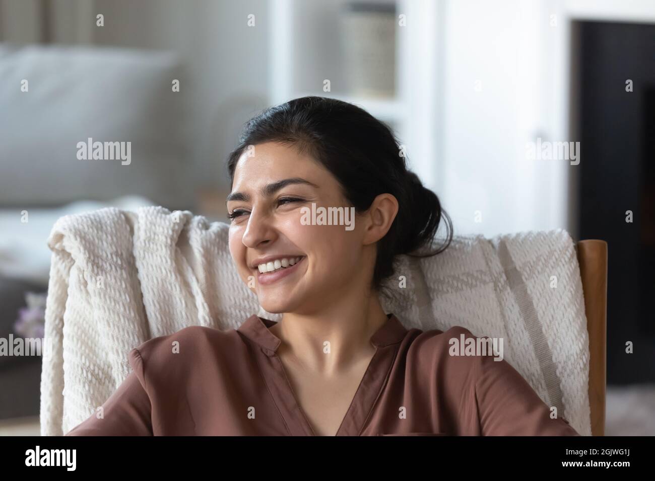 Joyful millennial indian woman relax at home laugh look aside Stock ...