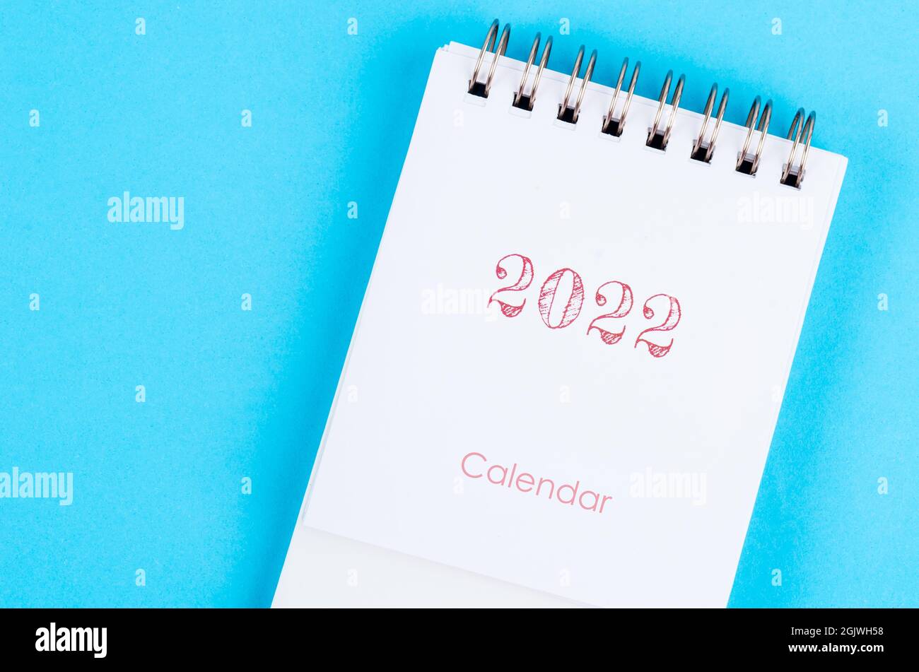 The mini desk calendar 2022 on blue background Stock Photo - Alamy