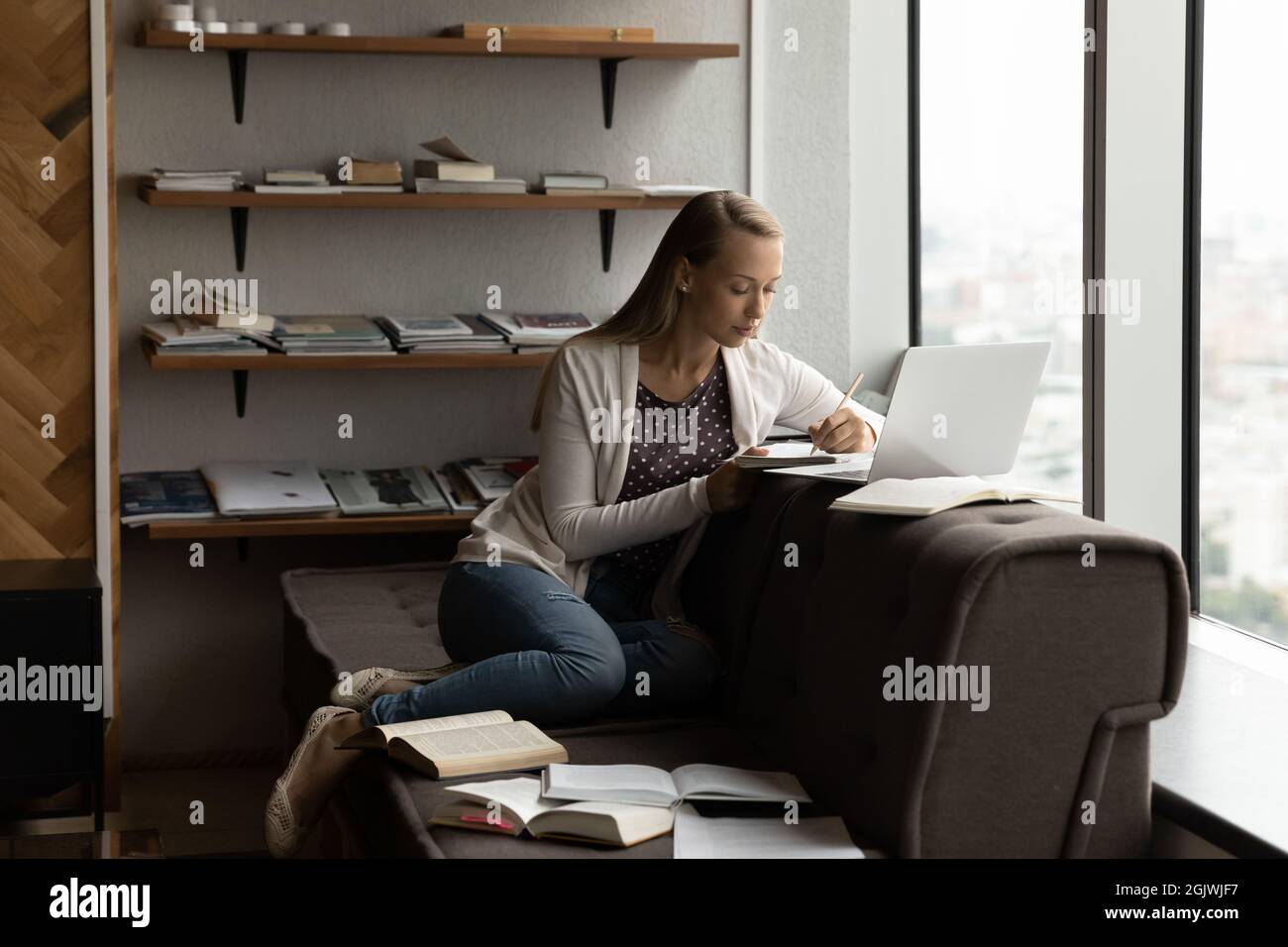 Smart female student use laptop study online with books Stock Photo - Alamy