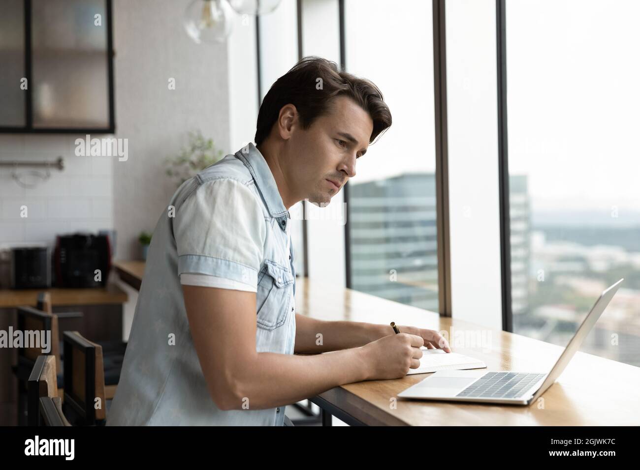 Young Caucasian male write using laptop gadget Stock Photo - Alamy