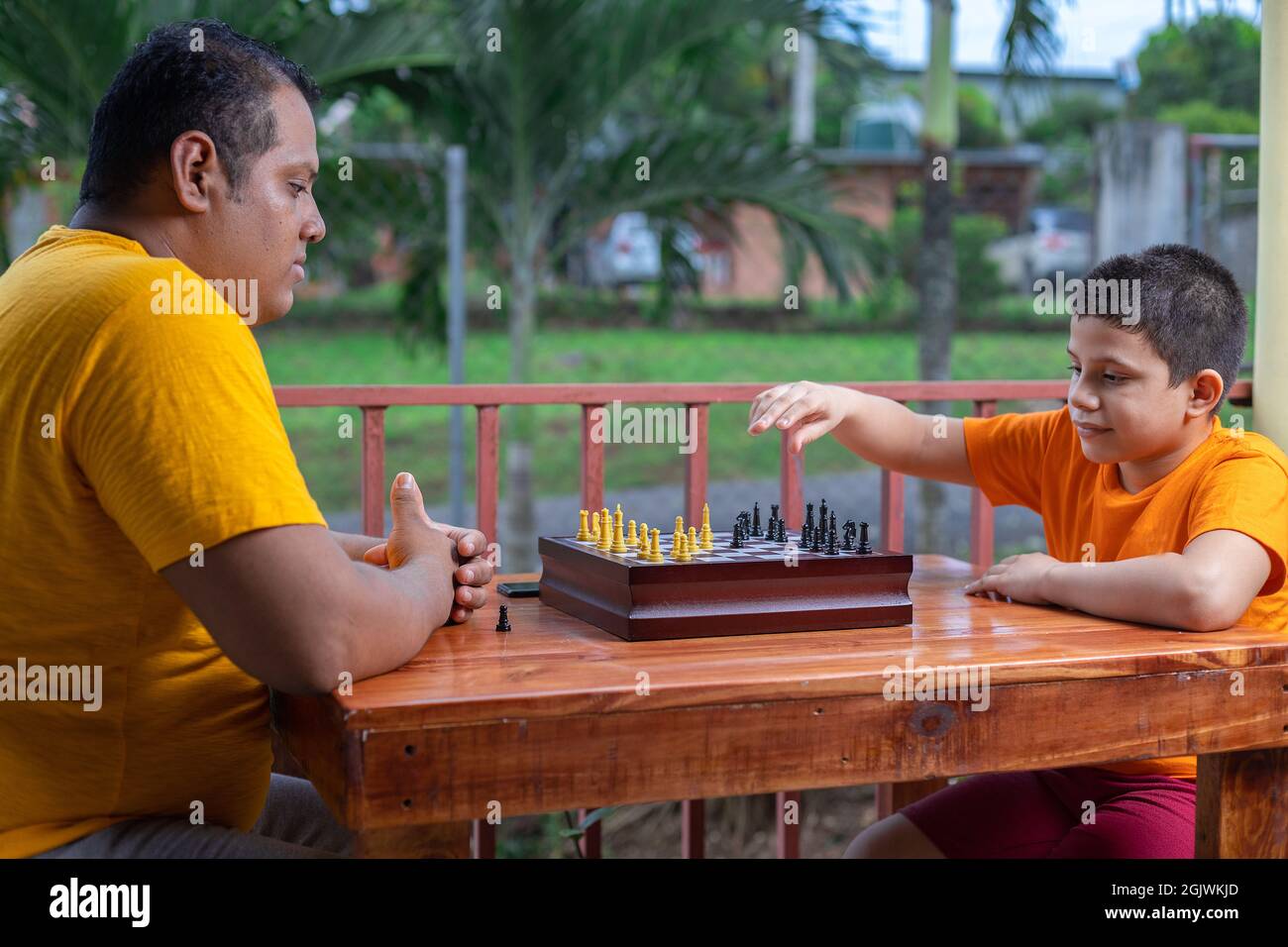 A father playing chess with his son Stock Photo - Alamy