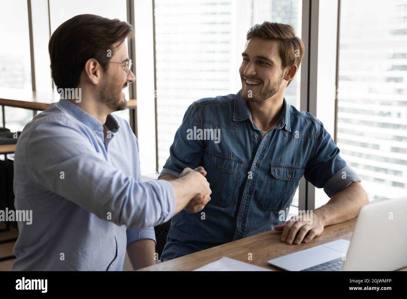 Happy employees greeting congratulating hi-res stock photography and ...