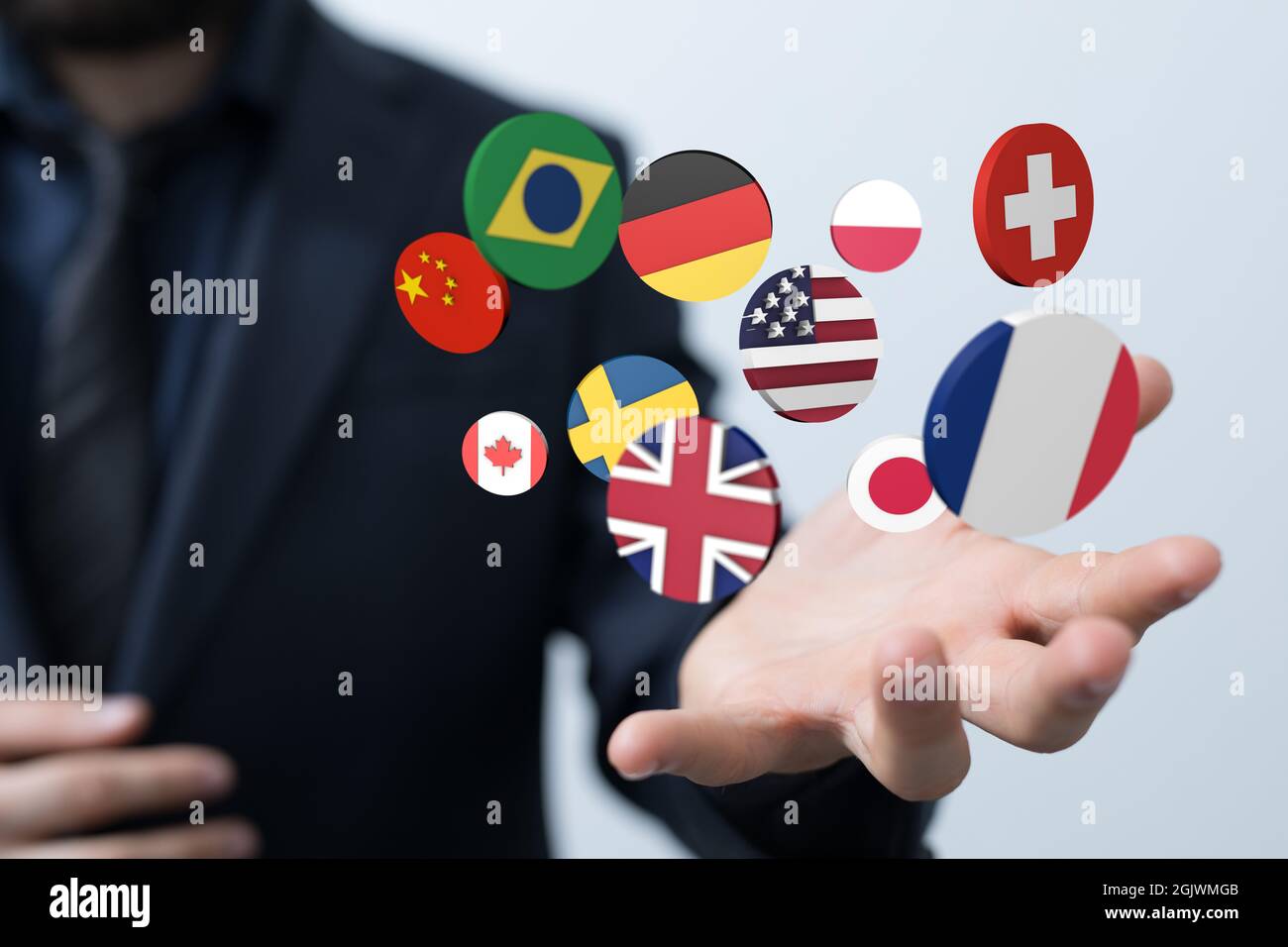 A closeup shot of round digital country flags above a hand Stock Photo ...