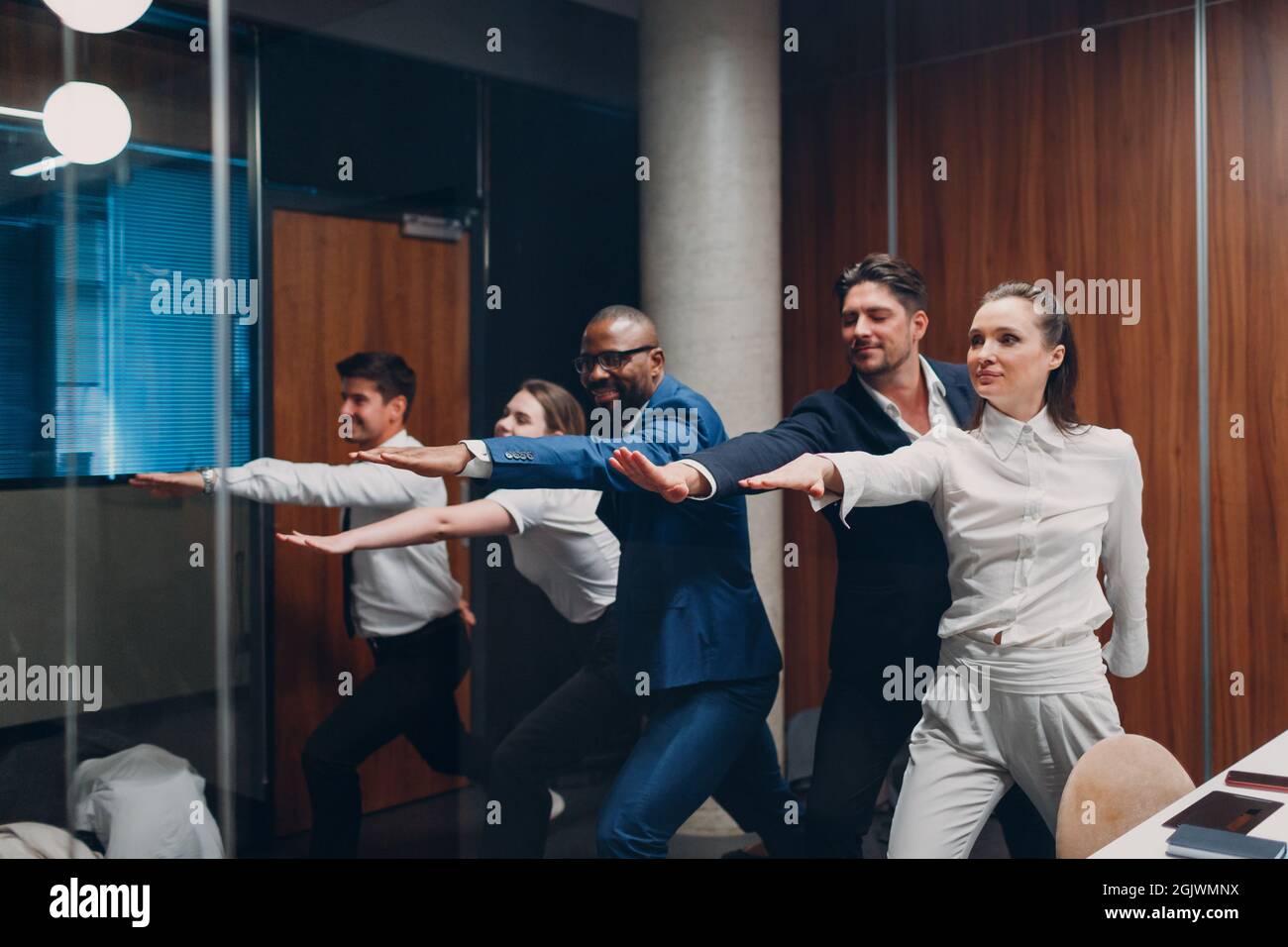 Businessman and businesswoman team doing warm up and yoga exercises ...