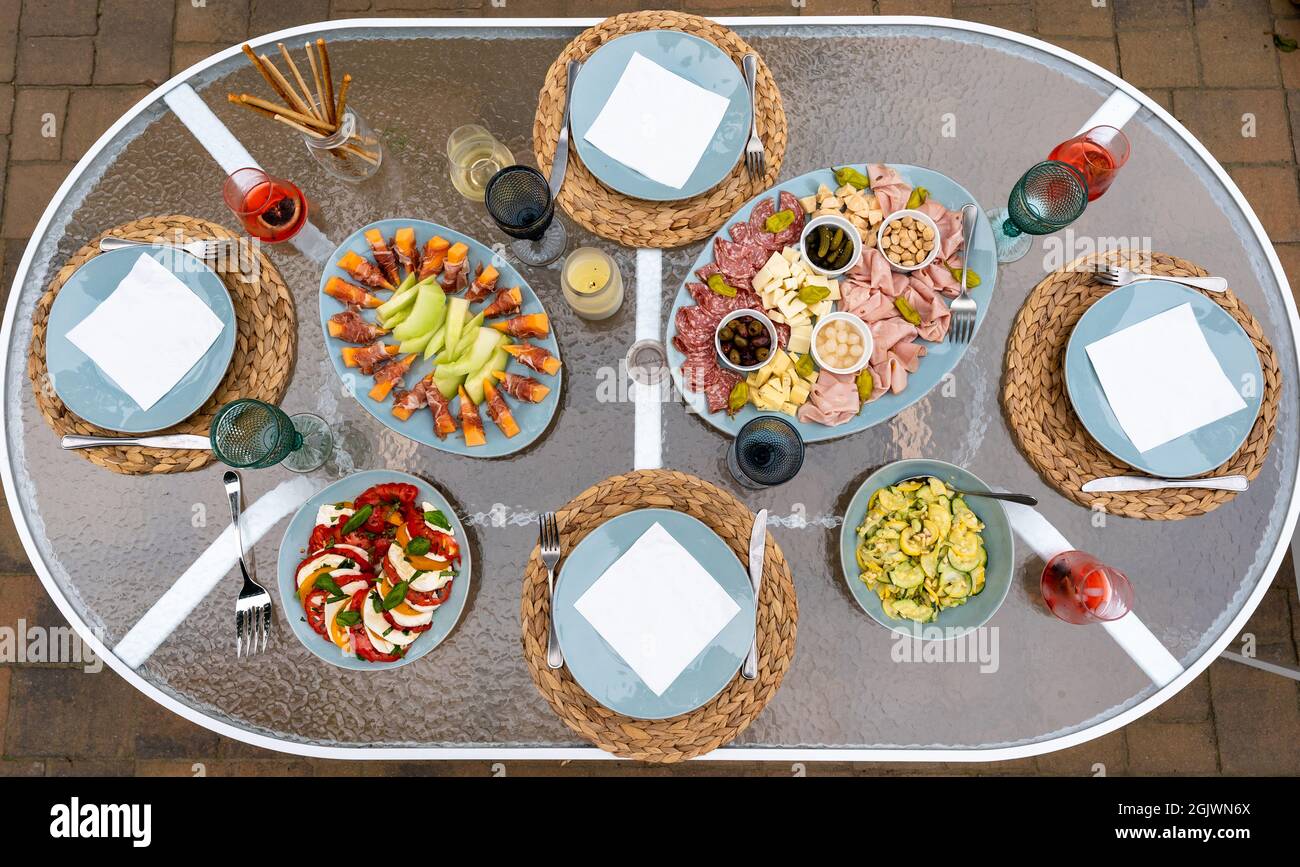 A panoramic top view of an outdoor dining table with Italian cocktails ...