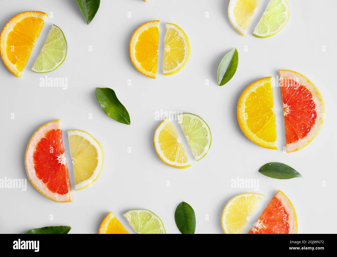 Composition of fresh slices of citrus fruits on white background Stock ...