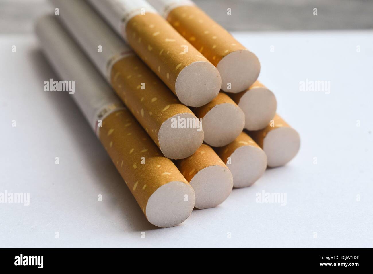 A pack of cigarette with an air filter on a white background, selective ...
