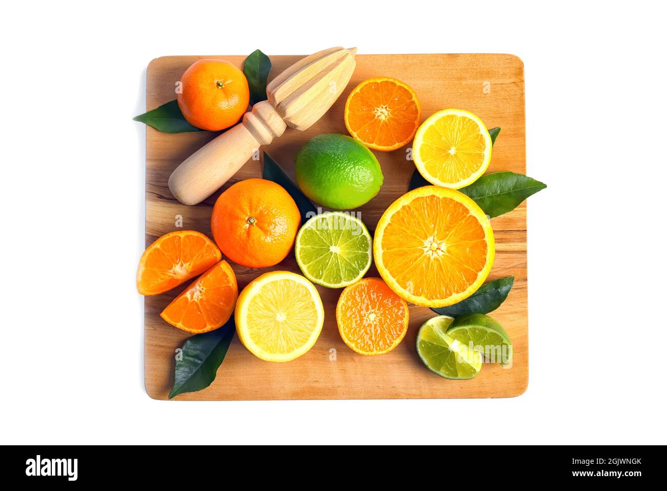 Wooden board with delicious citrus fruits and hand juicer on white ...