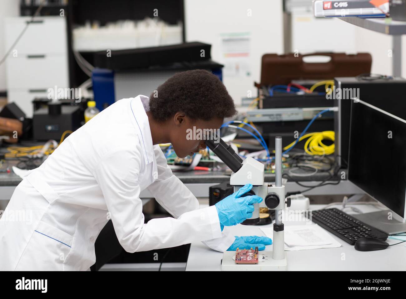 Scientist african american woman in gloves working in laboratory with ...