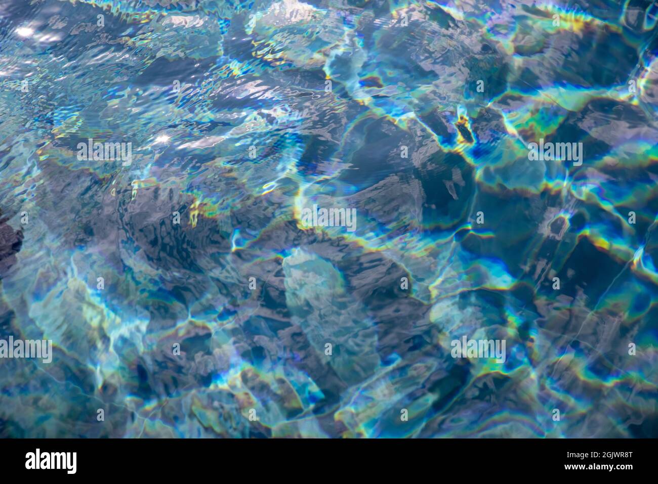 Shiny water of swimming pool on a sunny summer day. Close up of blue ...