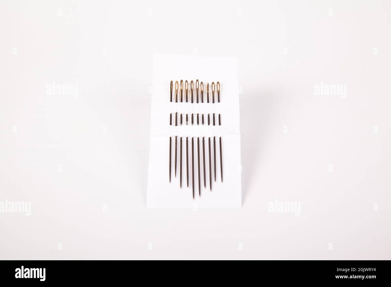 Set of steel sewing needles of various sizes for sewing, isolated on ...