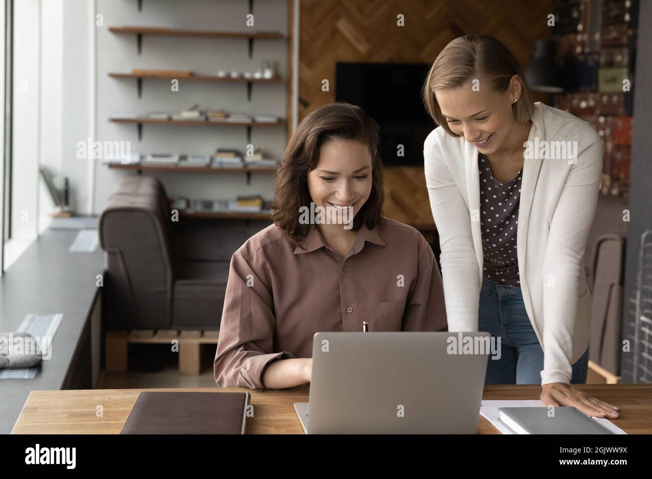 Smiling Caucasian female colleagues work together on computer Stock ...