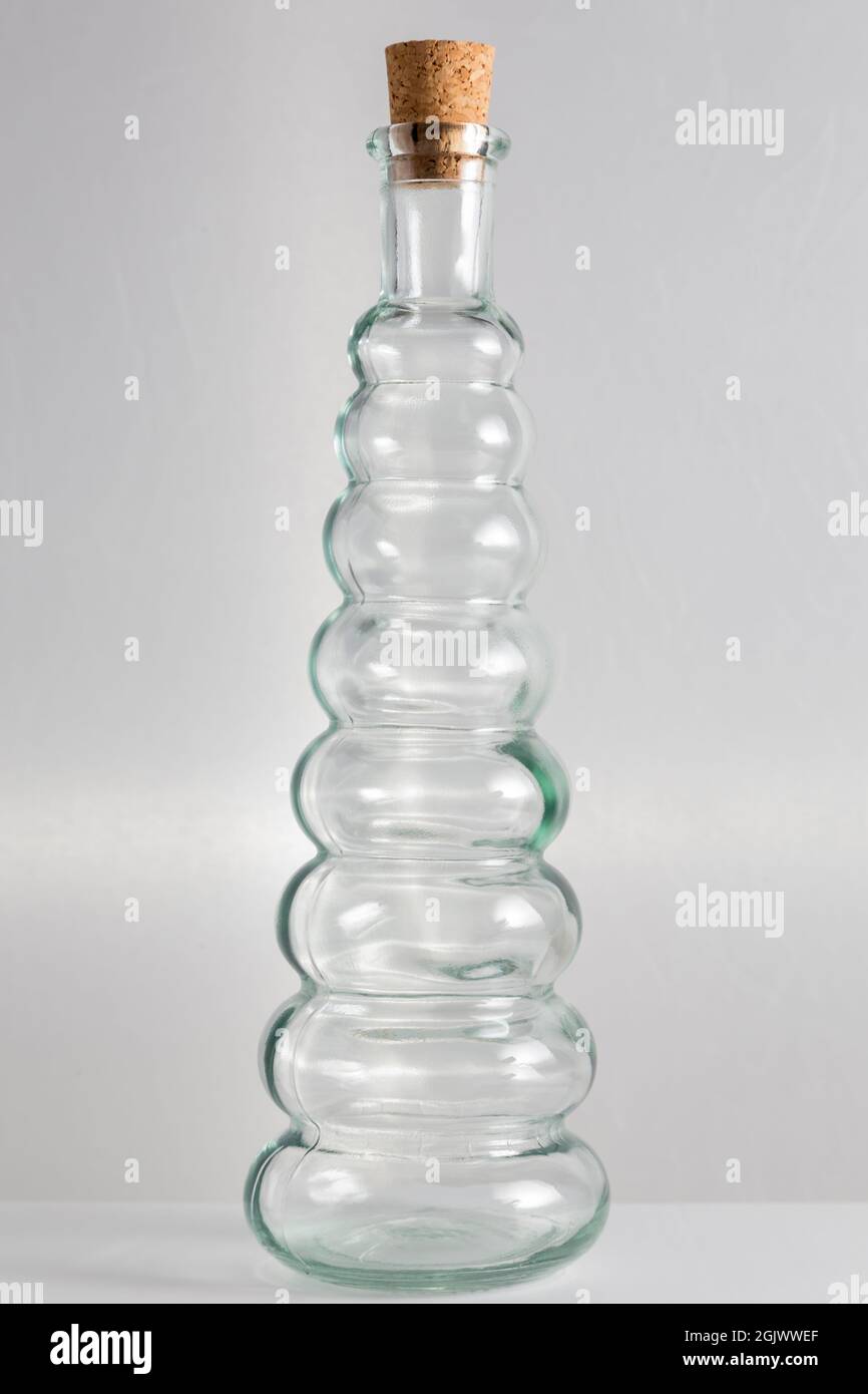 photograph of a glass bottle with curved and repetitive shapes ...