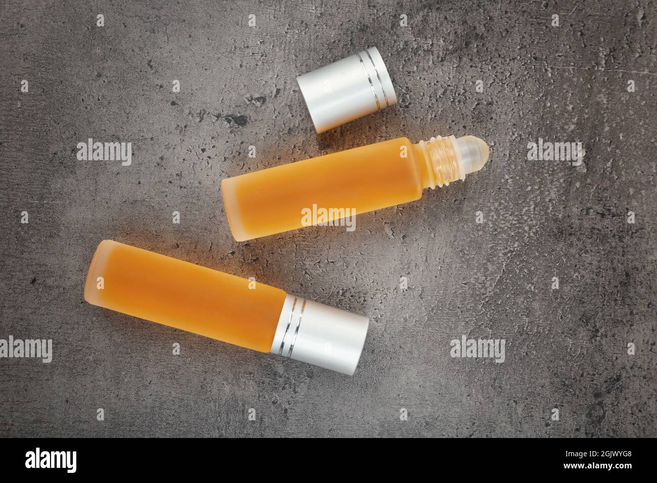 Bottles with perfume on grunge background Stock Photo - Alamy
