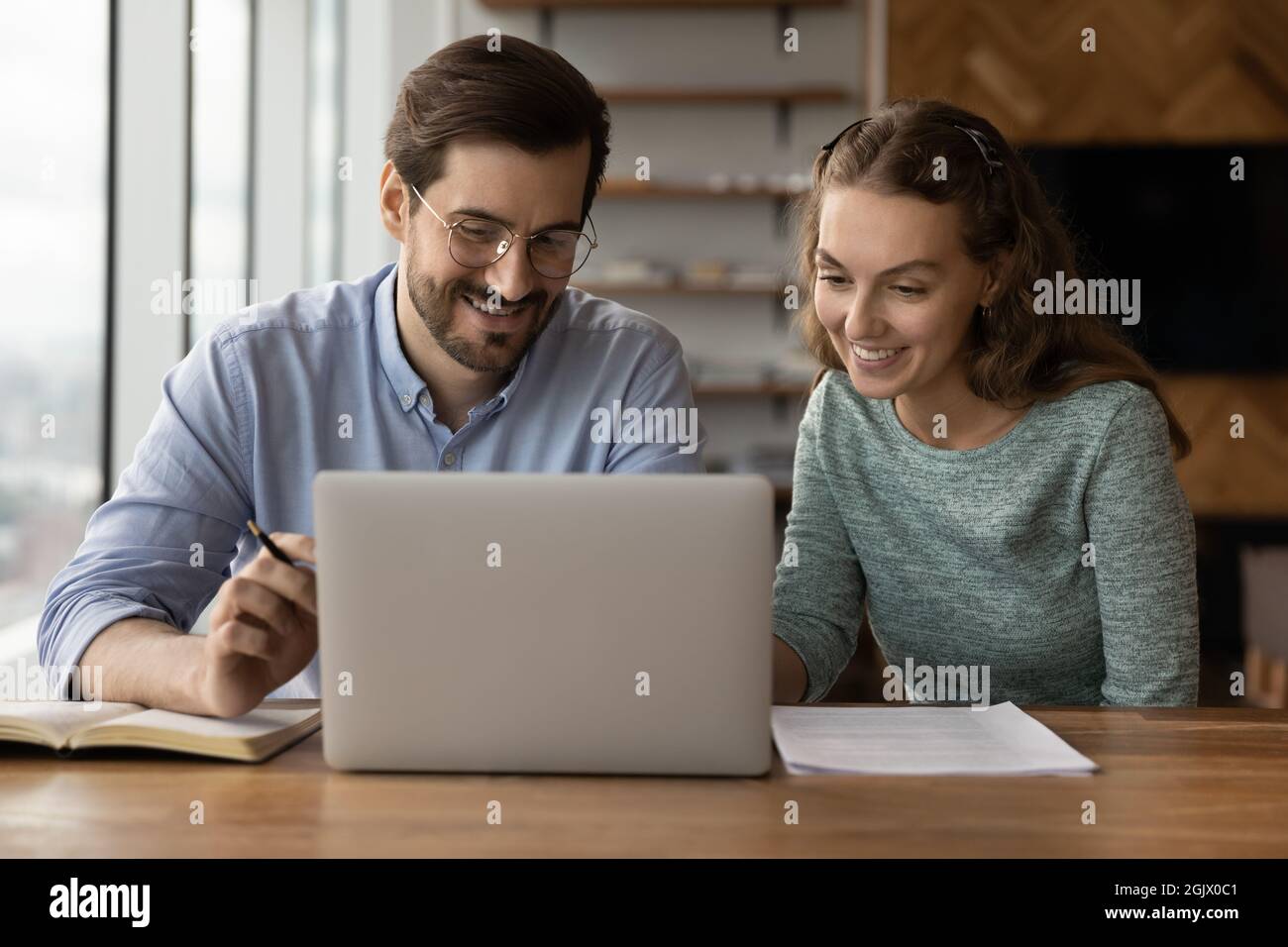 Smiling diverse colleagues brainstorm on computer in office Stock Photo ...