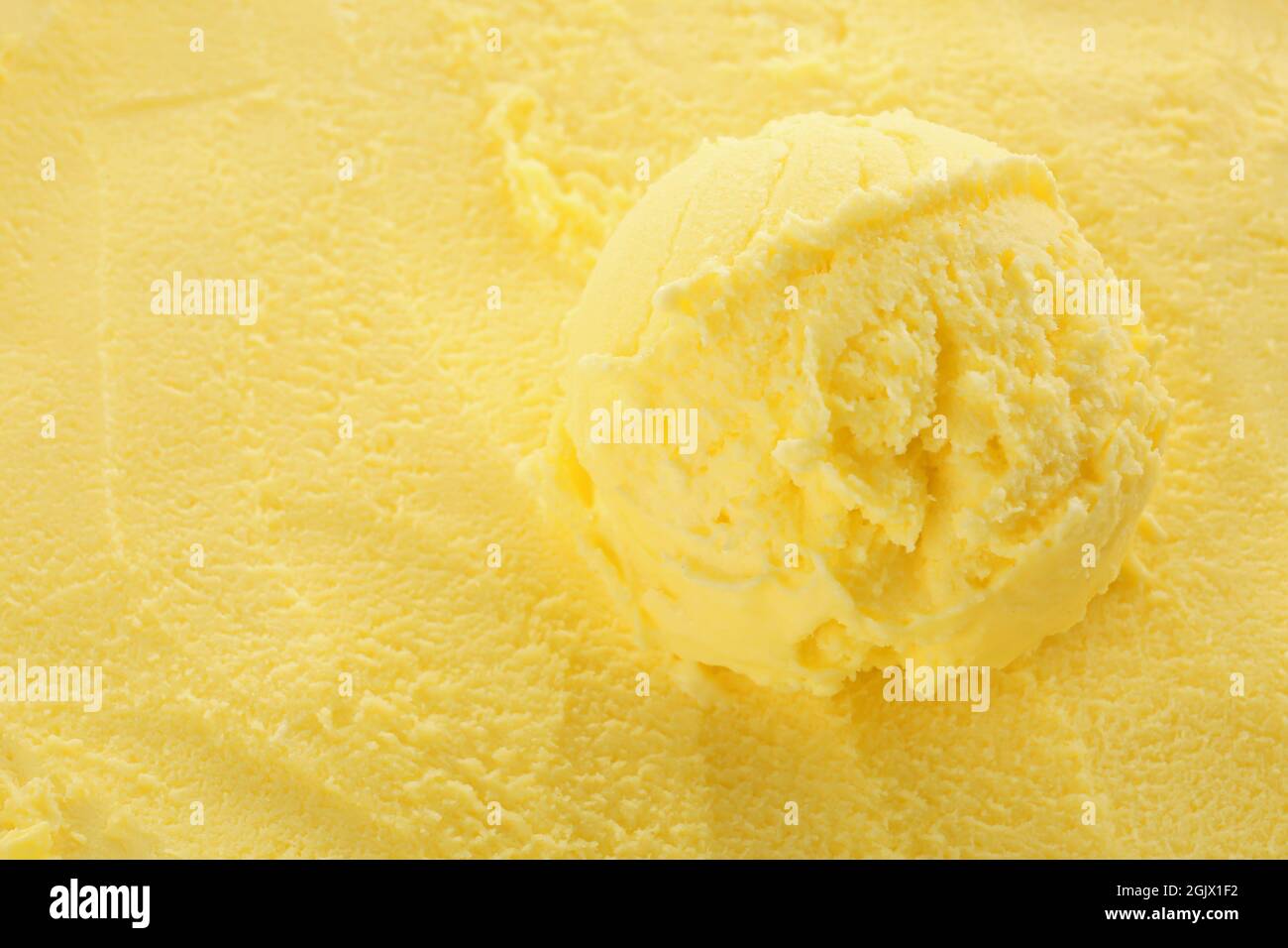 Ball of ice-cream on yellow textured background Stock Photo - Alamy