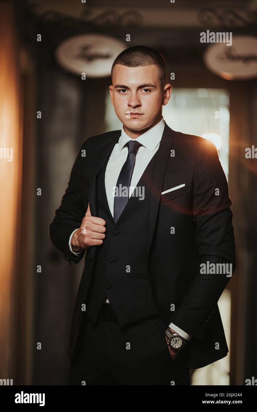 A vertical of a young Bosnian male posing in elegant black suit Stock ...