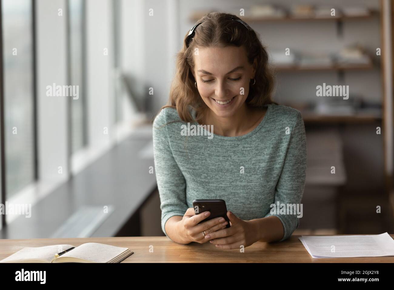 Smiling Caucasian woman use cellphone browsing internet Stock Photo - Alamy
