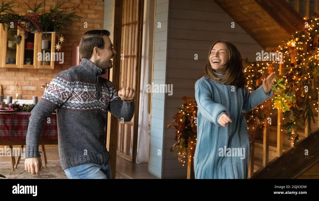 Happy active millennial family couple having fun indoors Stock Photo ...