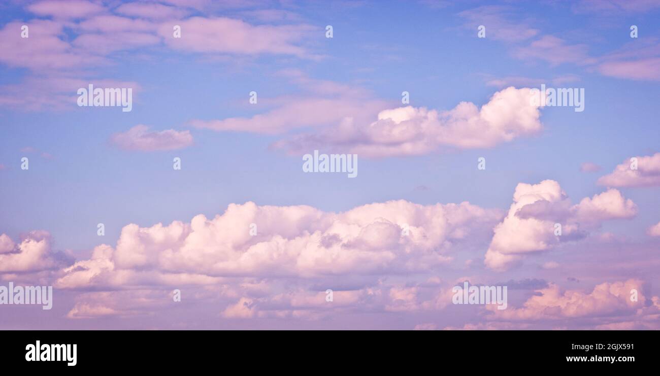 The sky with blurred cirrus and cumulus clouds illuminated by the ...