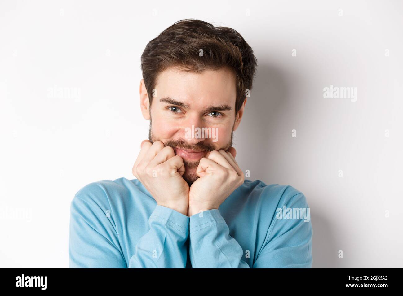 Cute caucasian man looking at something with admiration and desire ...