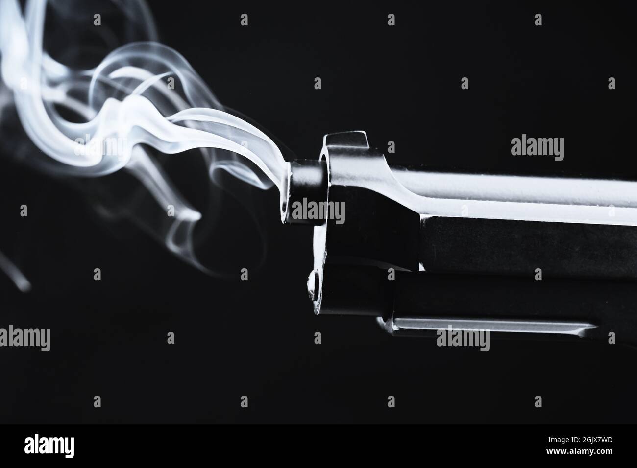 Smoking gun on black background Stock Photo - Alamy