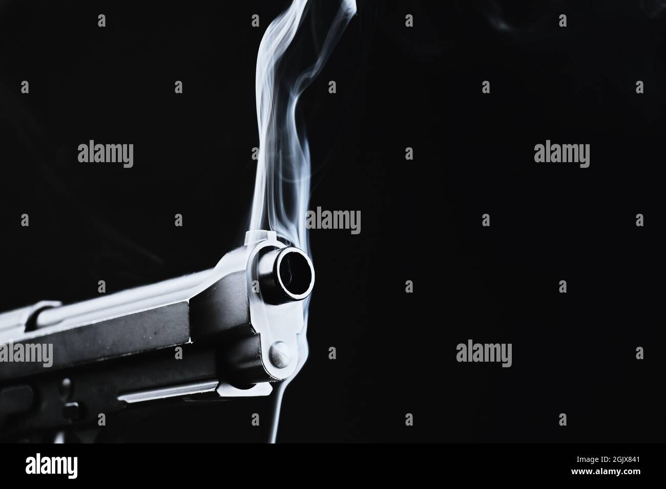 Smoking gun on black background Stock Photo - Alamy