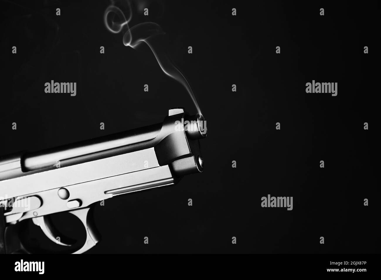 Smoking gun on black background Stock Photo - Alamy