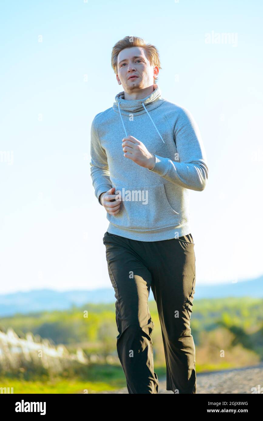 Running man jogging in rural nature at beautiful summer day. Sport ...