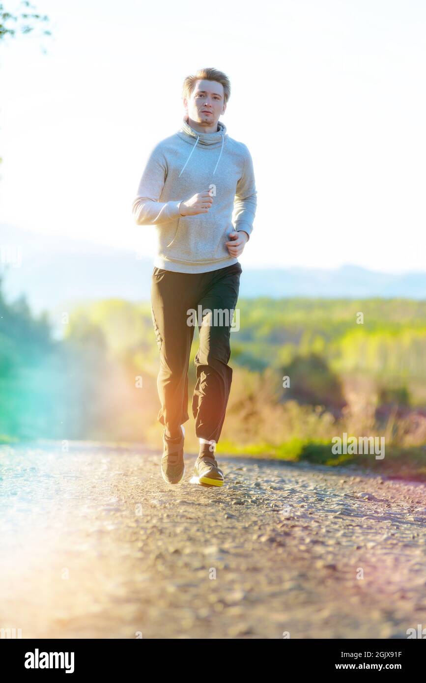 Running man jogging in rural nature at beautiful summer day. Sport ...