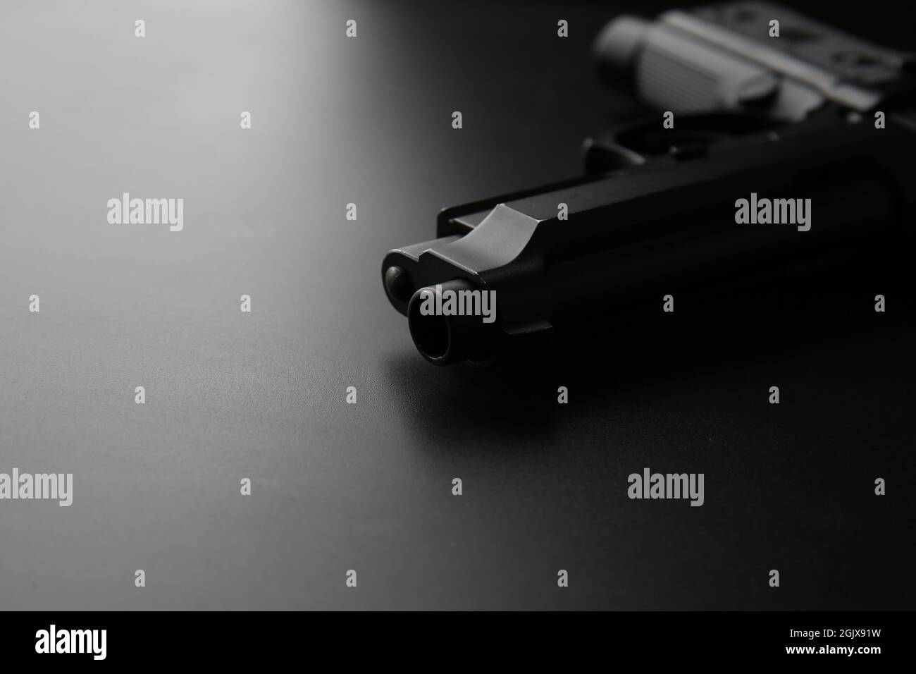 Gun on black background Stock Photo - Alamy