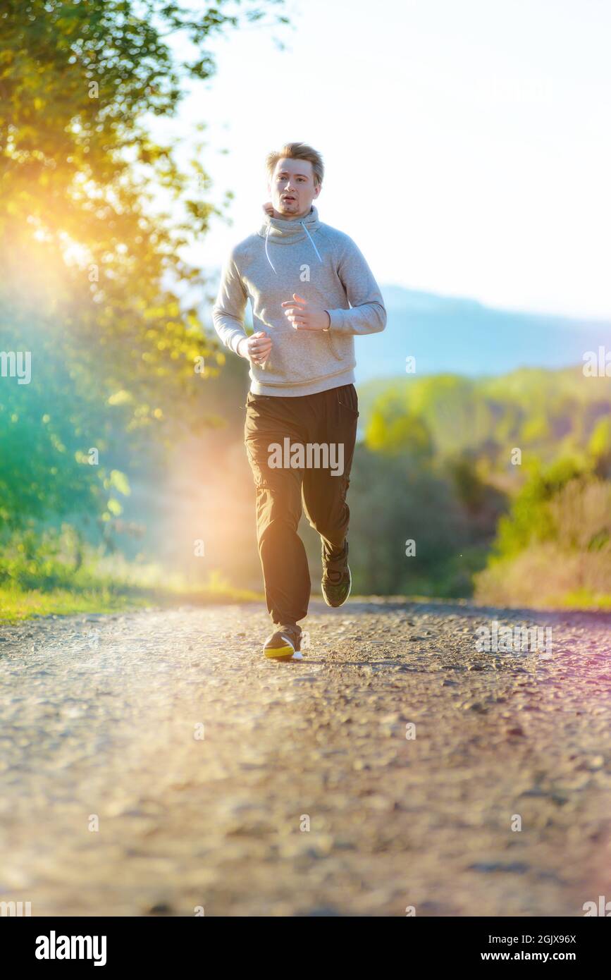 Running man jogging in rural nature at beautiful summer day. Sport ...