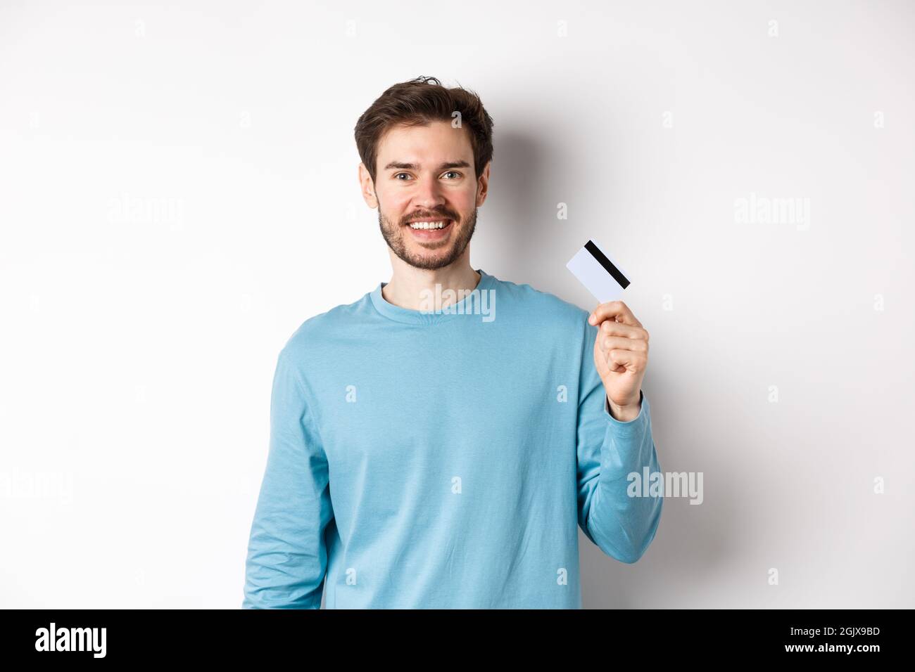 Smiling male bank client showing plastic credit card with happy face ...