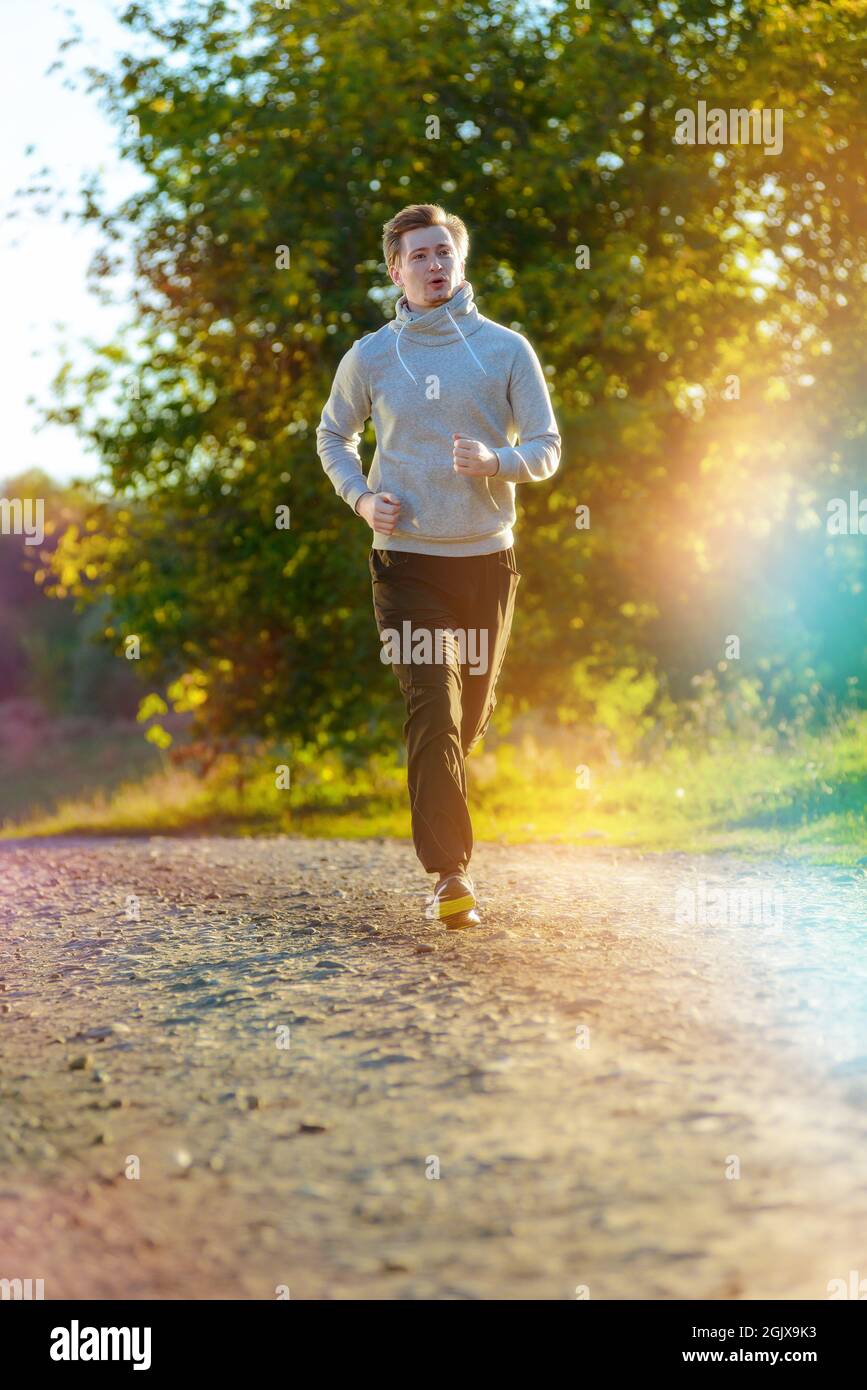 Running man jogging in rural nature at beautiful summer day. Sport ...