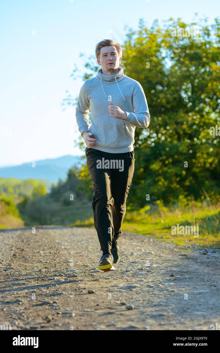 Running man jogging in rural nature at beautiful summer day. Sport ...