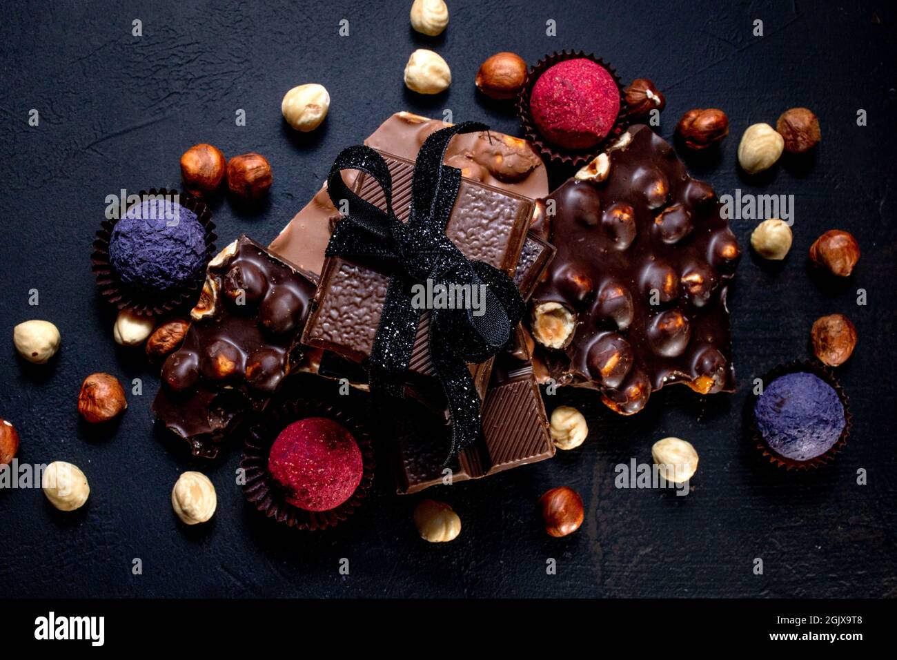 Chocolate bar, crushed pieces of dark chocolate and nuts. Praline ...