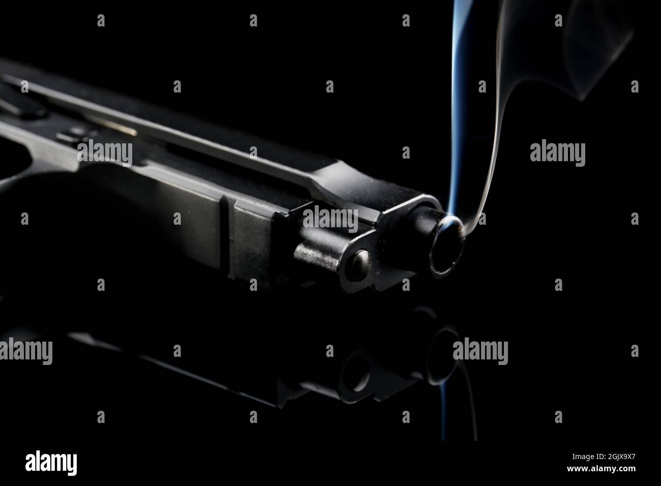 Smoking gun on black background Stock Photo - Alamy