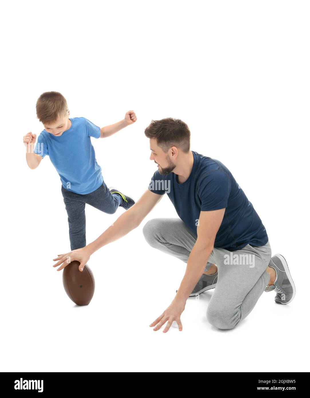 Handsome man playing rugby with his son on white background Stock Photo ...