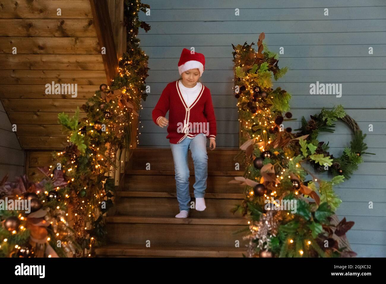 Funny small adorable child girl hurrying up opening gifts Stock Photo ...