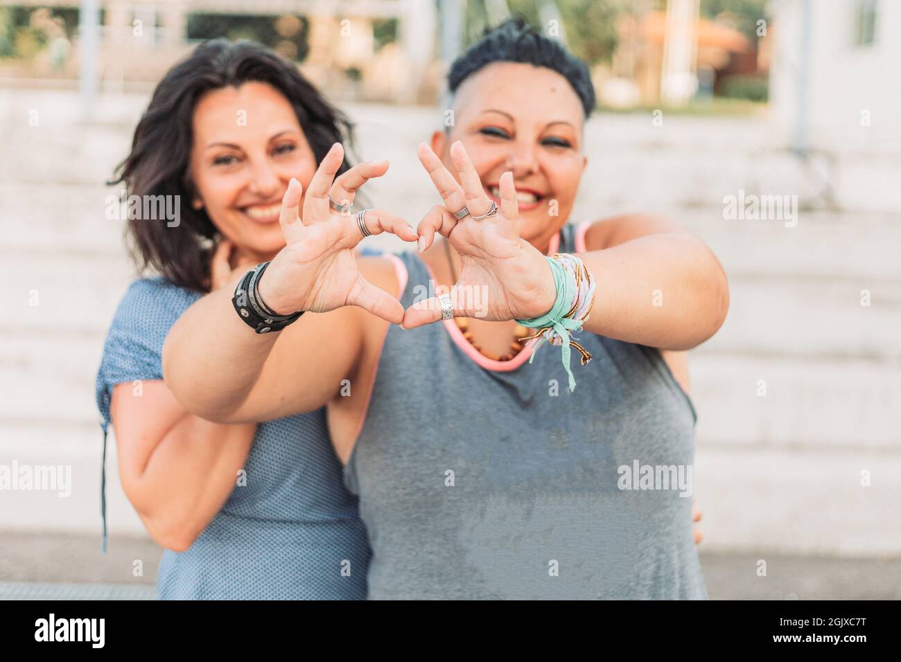 Portrait of two adult brunette twin sisters. Different styles Stock ...