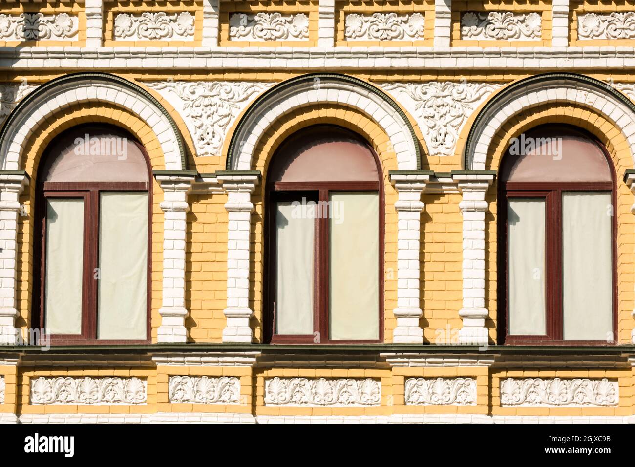 Arched windows with decorated brick stone background Stock Photo - Alamy
