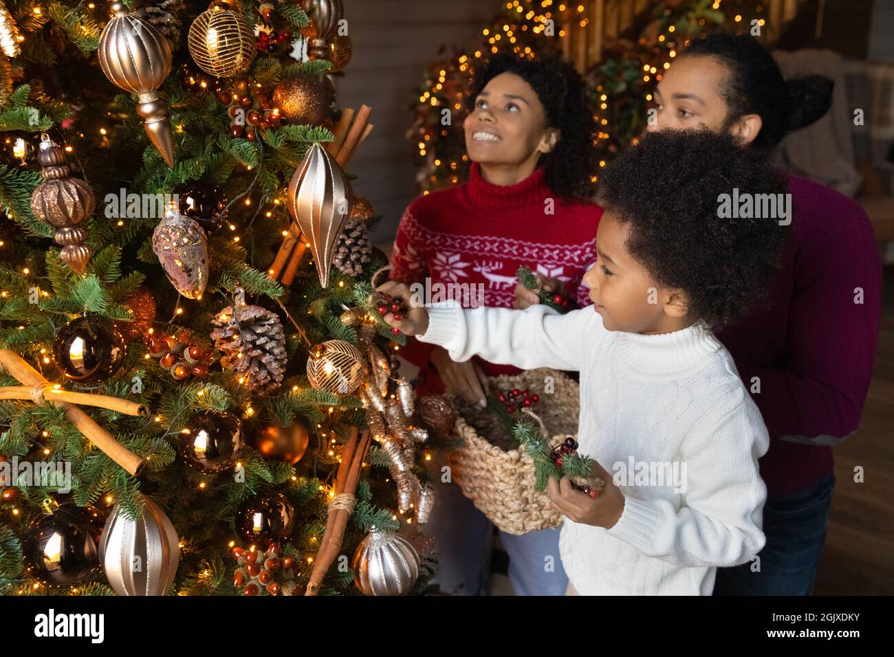 Happy biracial family decorate Christmas tree together Stock Photo - Alamy