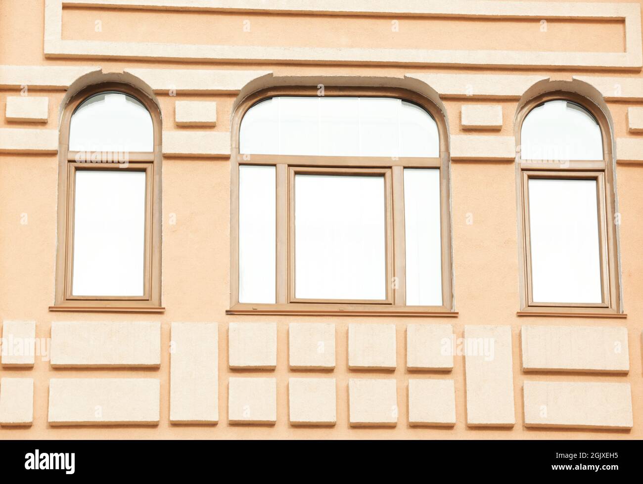 Modern building with arched brown windows Stock Photo - Alamy