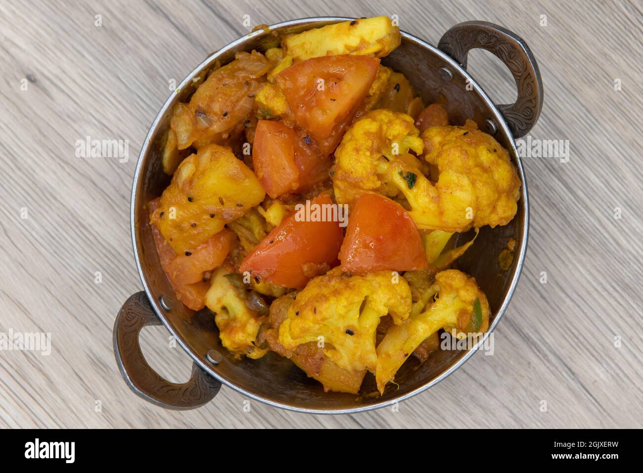 Overhead view of aloo gobi flavored vegetables in a bowl from Indian ...