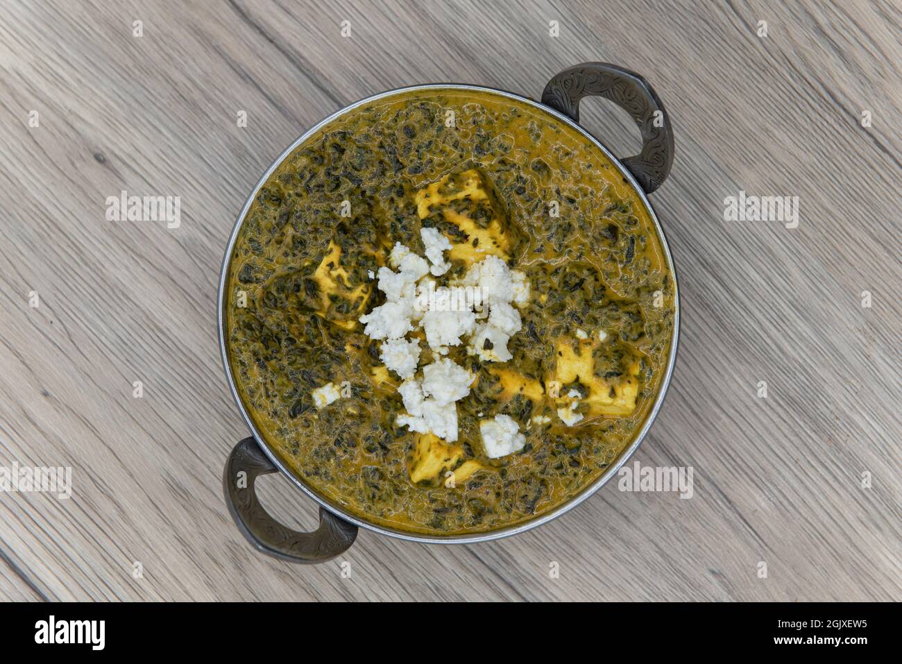 Overhead view of sag paneer flavored spinach in a bowl from Indian ...