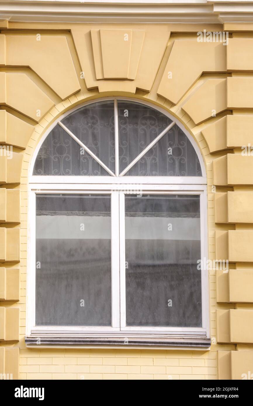 Arched white window with sand wall background Stock Photo - Alamy