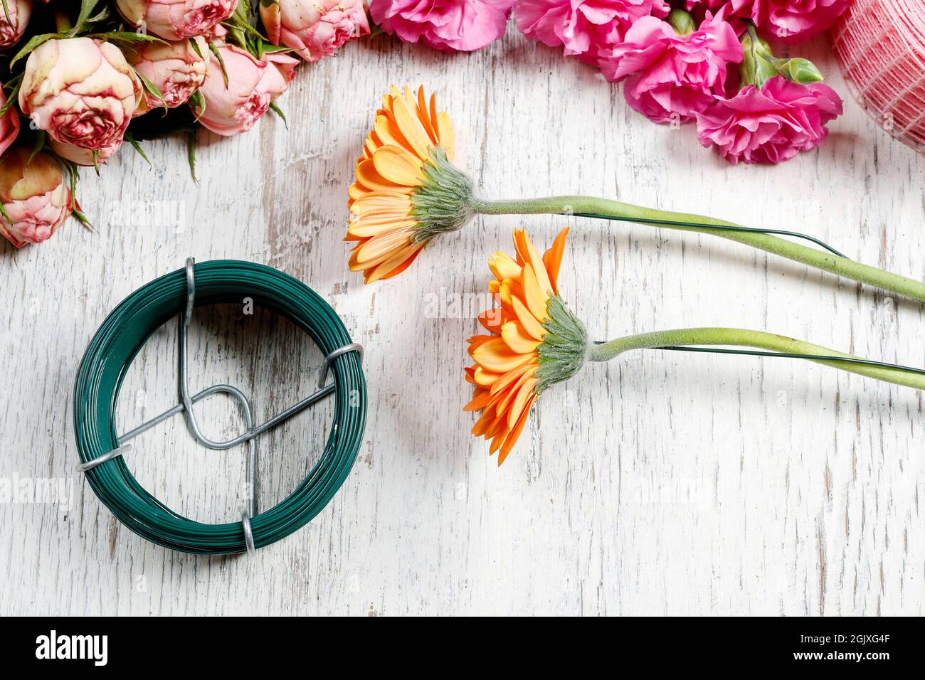 Basic techniques of arranging flowers: wiring and taping gerberas Stock ...