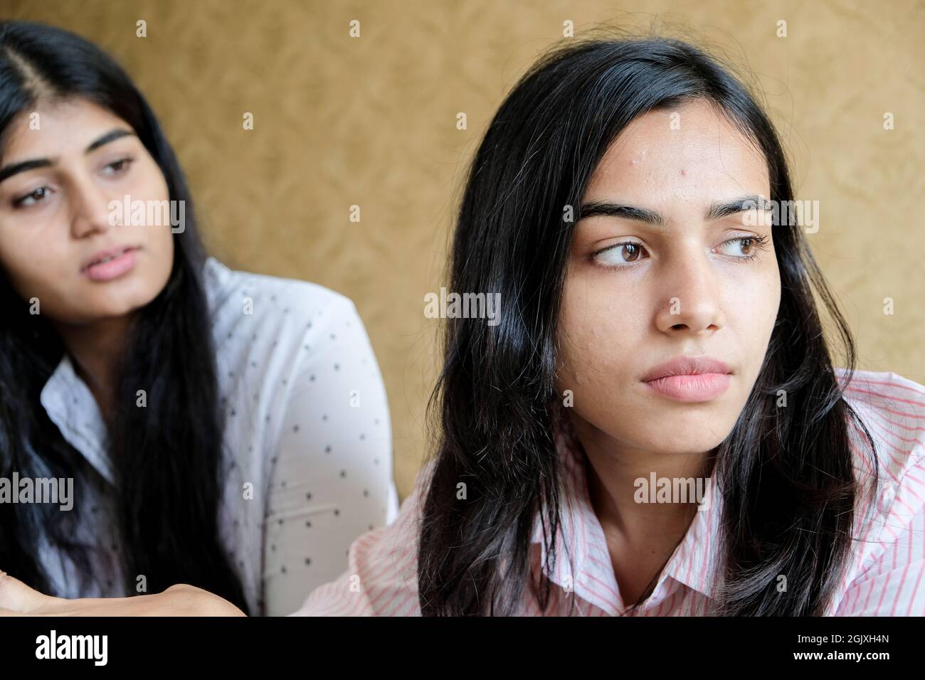 Two Indian friends talking about a problem between the, at home Stock ...